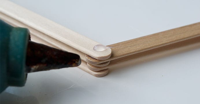 Glue popsicle sticks together to create this craft.