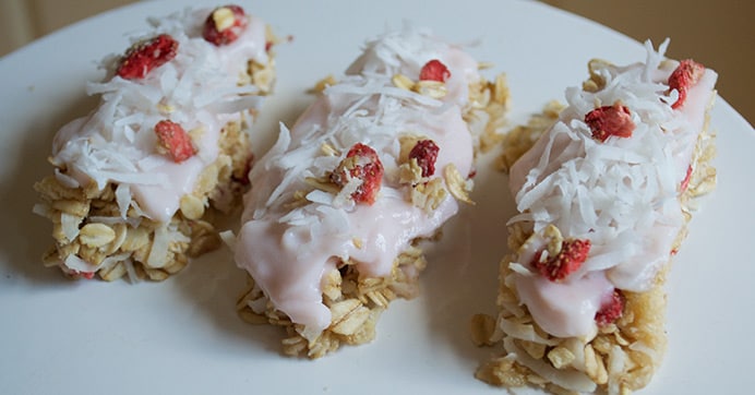 Granola bars with yogurt, coconut and strawberries on therm.
