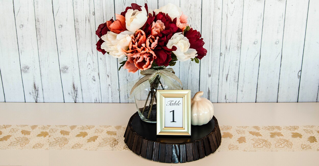 Red, ivory, and blush peonies, an ivory pumpkin, and a table number ...
