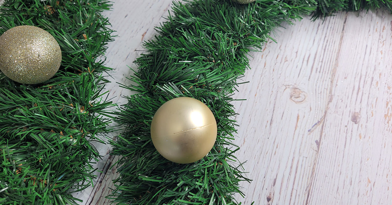garland wreath with gold ornaments on it