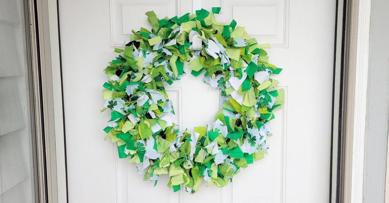 A round wreath made with a variety of green and white St. Patrick’s Day ...