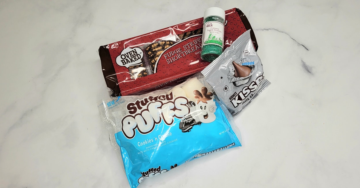 A bag of marshmallows, cookies, and a small bag of chocolate kisses.