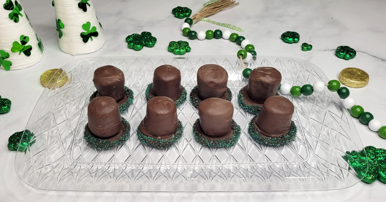 Two cones wrapped with white yarn and embellished with green foil ...