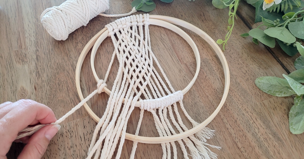 Two bamboo rings with a piece of macrame cotton twine tied on it.