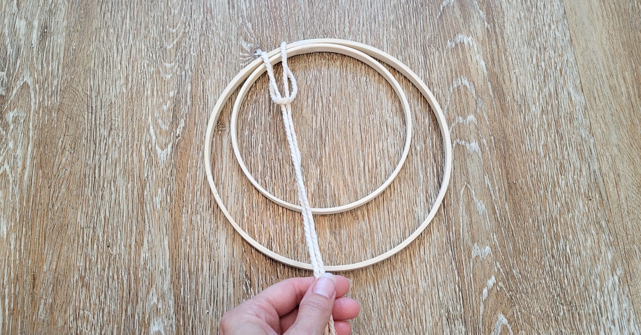 Two bamboo rings with a piece of macrame cotton twine.