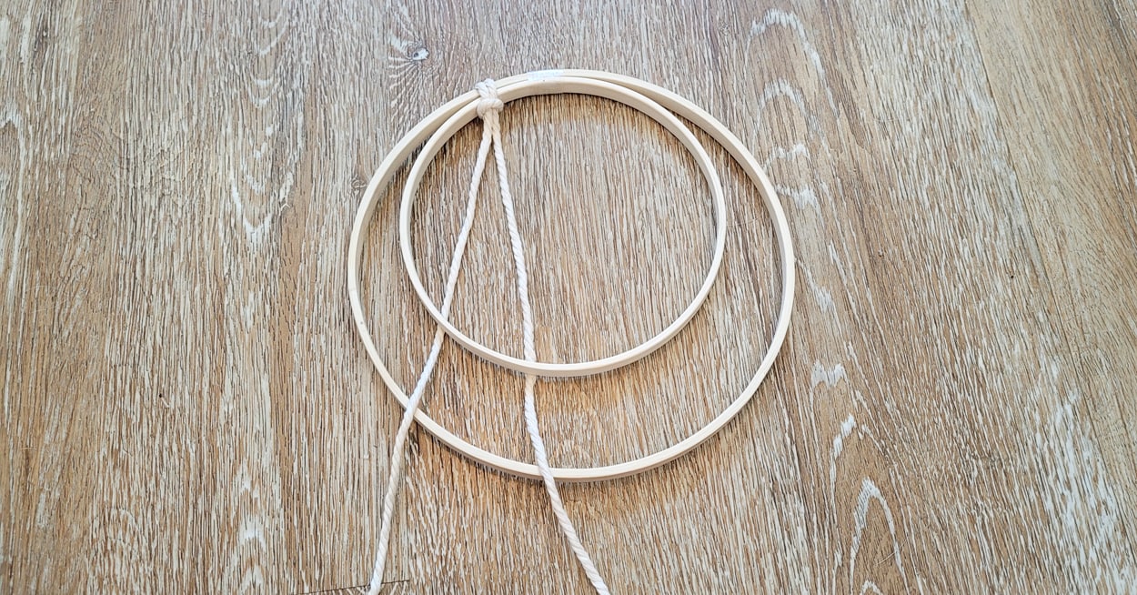 Two bamboo rings with a piece of macrame cotton twine tied on it.