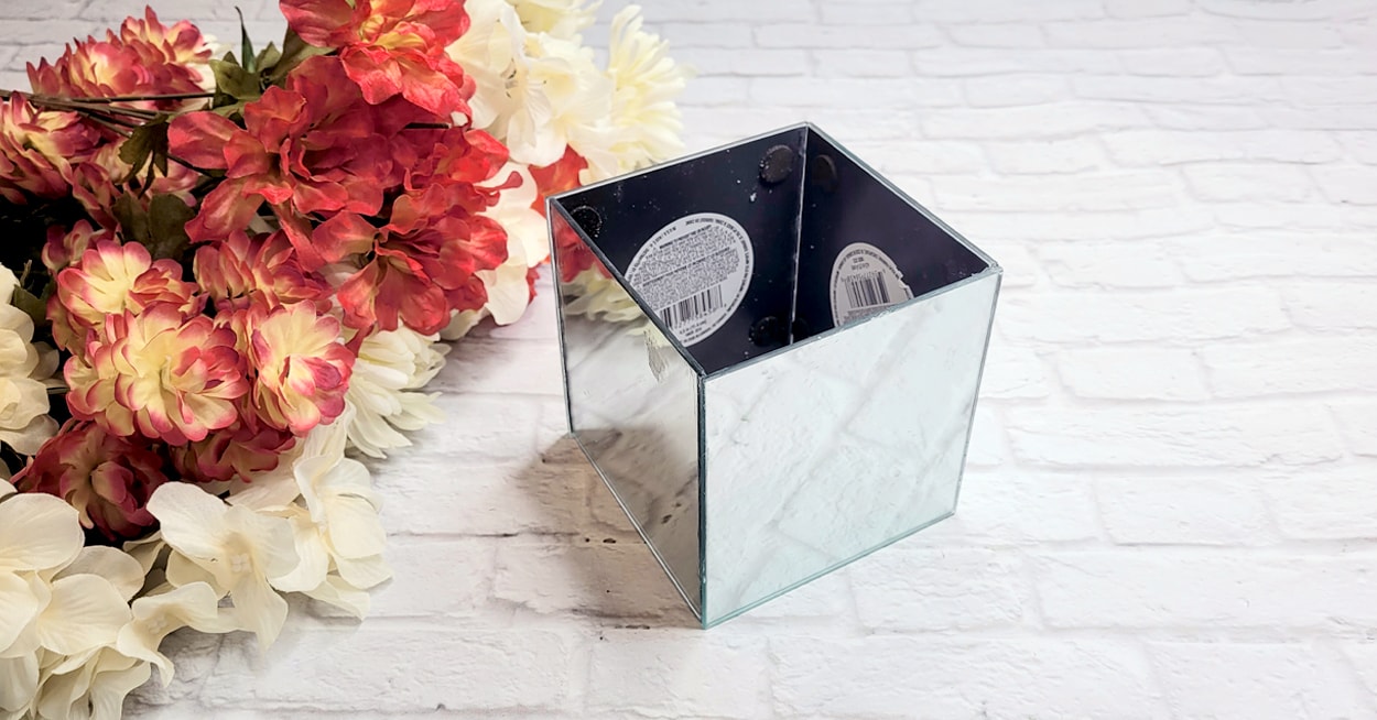 A mirrored box and flowers.