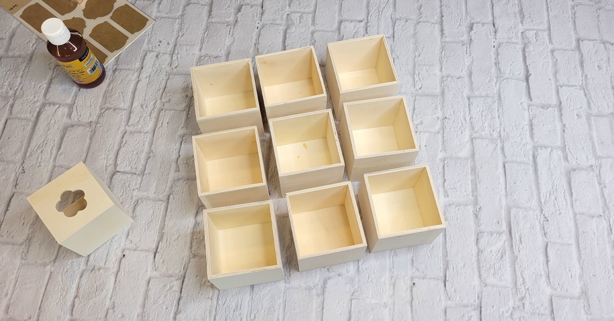 Nine small wooden boxes, a sheet of labels.