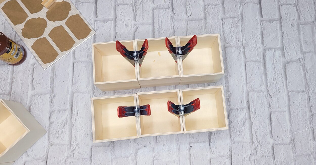 Small wooden boxes with clamps holding them together.