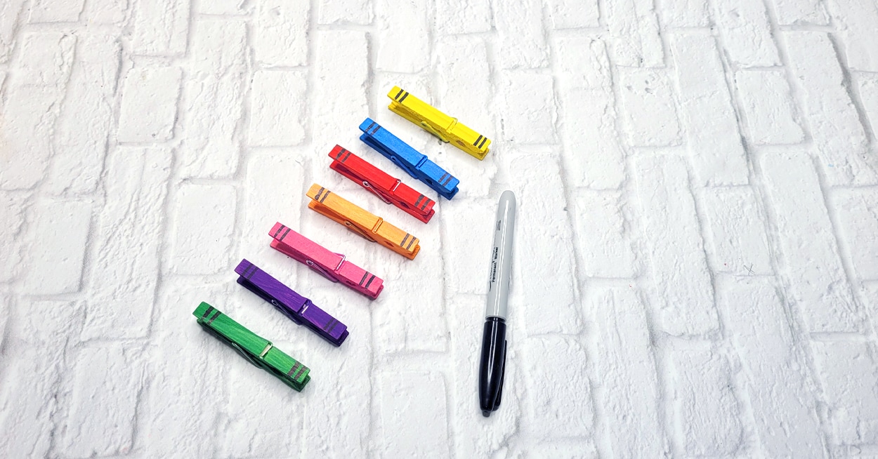 Different colored clothespins with names written on them and a ...