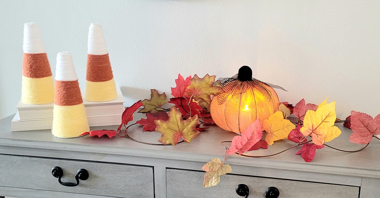 Three small candy corn trees made of yarn, fall leaves, and an orange ...