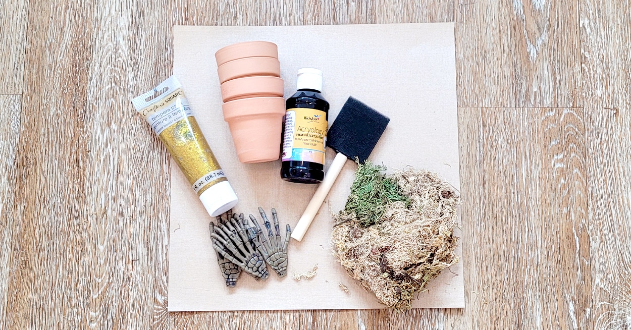 Small pots, skeleton hands, moss, black and gold paint, cardstock, and ...