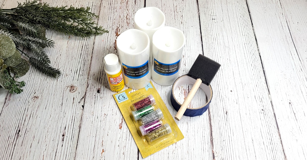 Three LED pillar candles, a pack of small tubes of glitter, a sponge ...