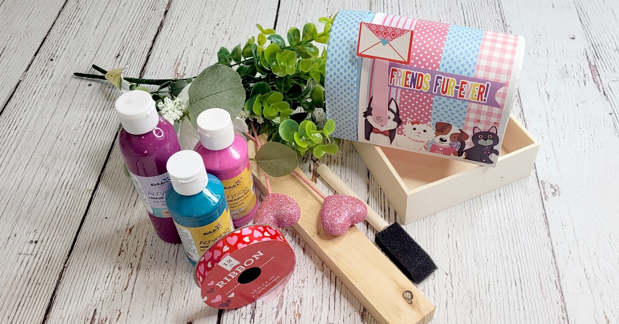 Paint, greenery and flowers, ribbon, glitter hearts, a small mailbox ...
