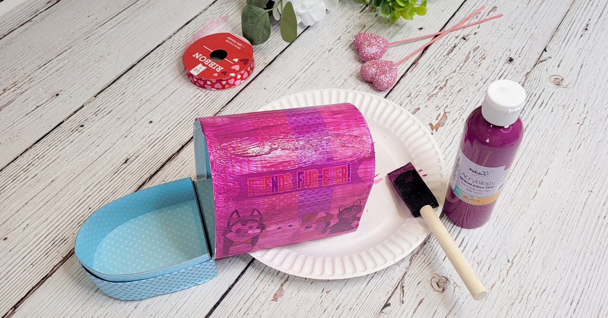 A small mailbox, purple paint, and a sponge brush.