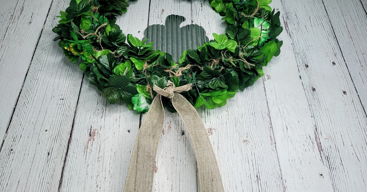 A long piece of burlap ribbon attached to green clover wreath.