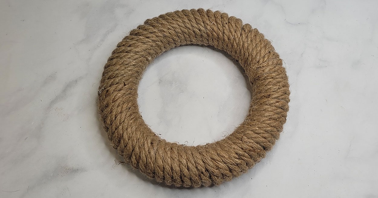A small foam wreath with some nautical rope wrapped around it.