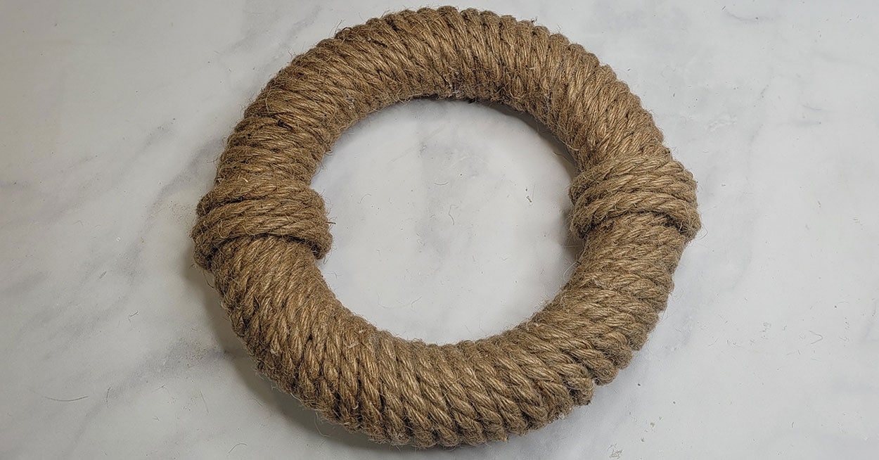 A small foam wreath with some nautical rope wrapped around it and extra ...