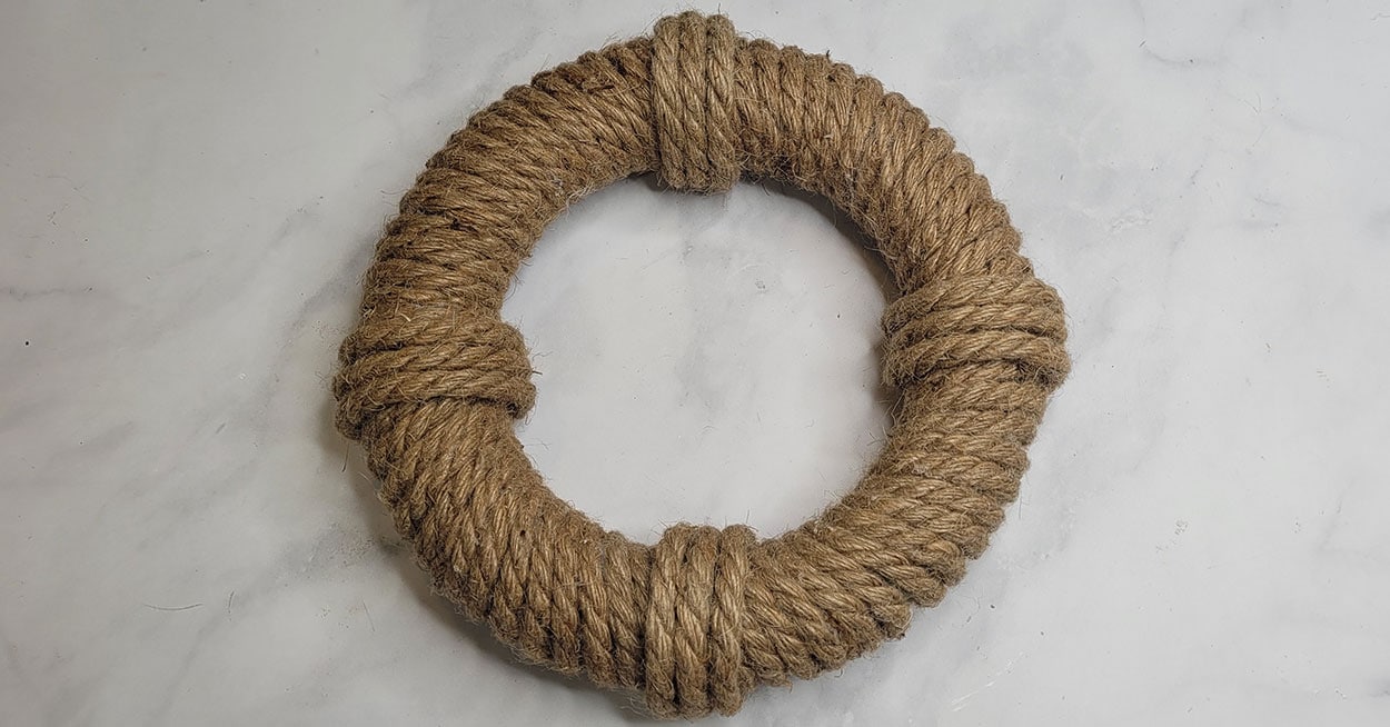 A small foam wreath with some nautical rope wrapped around it and extra ...